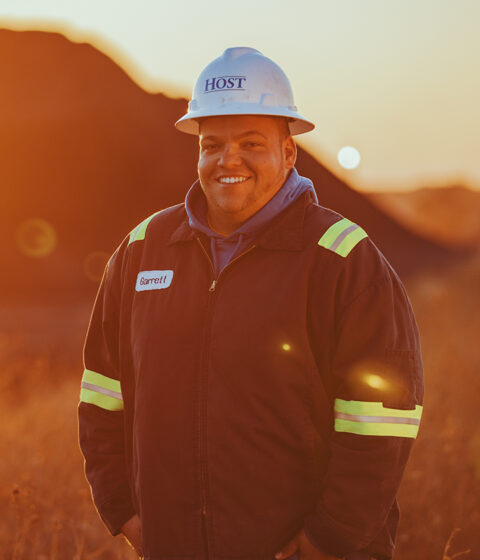 Host worker smiling with sunset in background